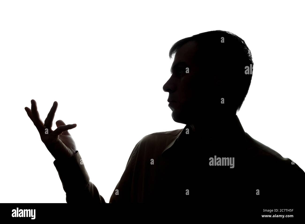Portrait of a young man with his hand raised, side view - silhouette ...