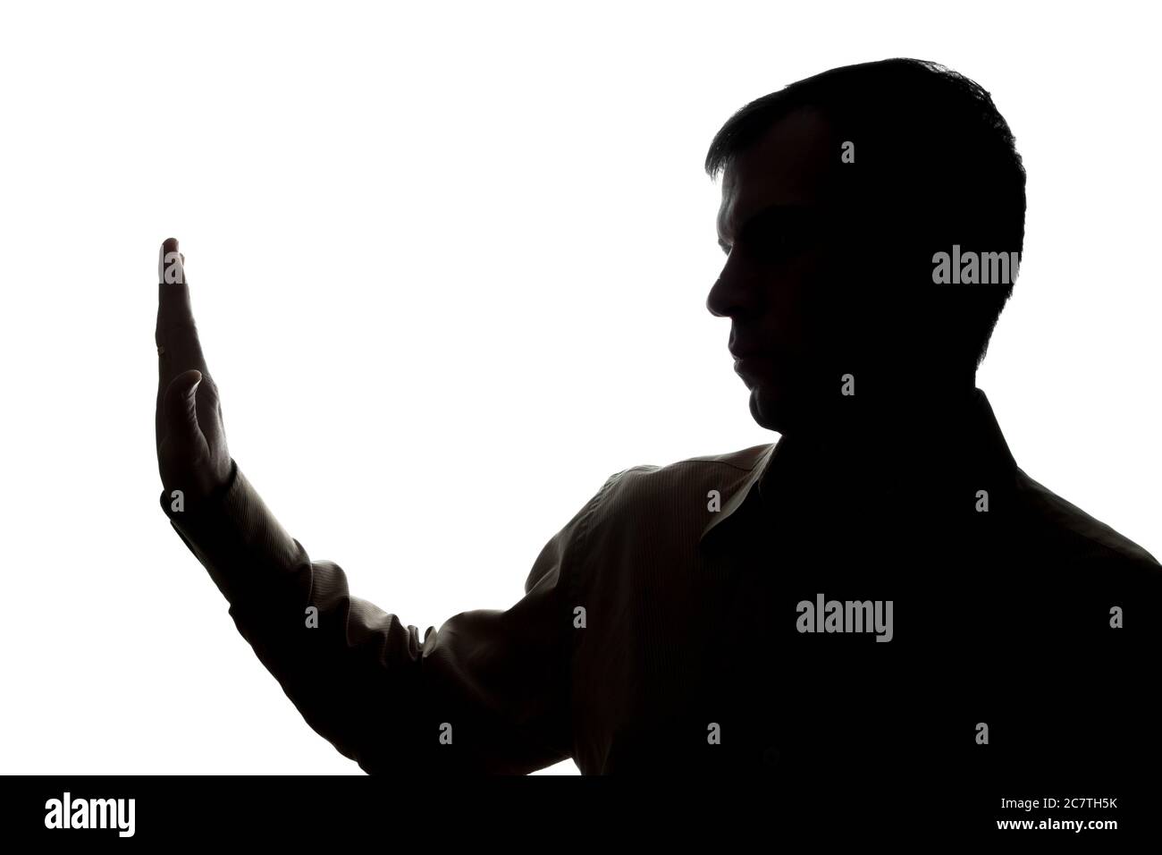 Portrait of a young man with his hand raised, side view - silhouette ...