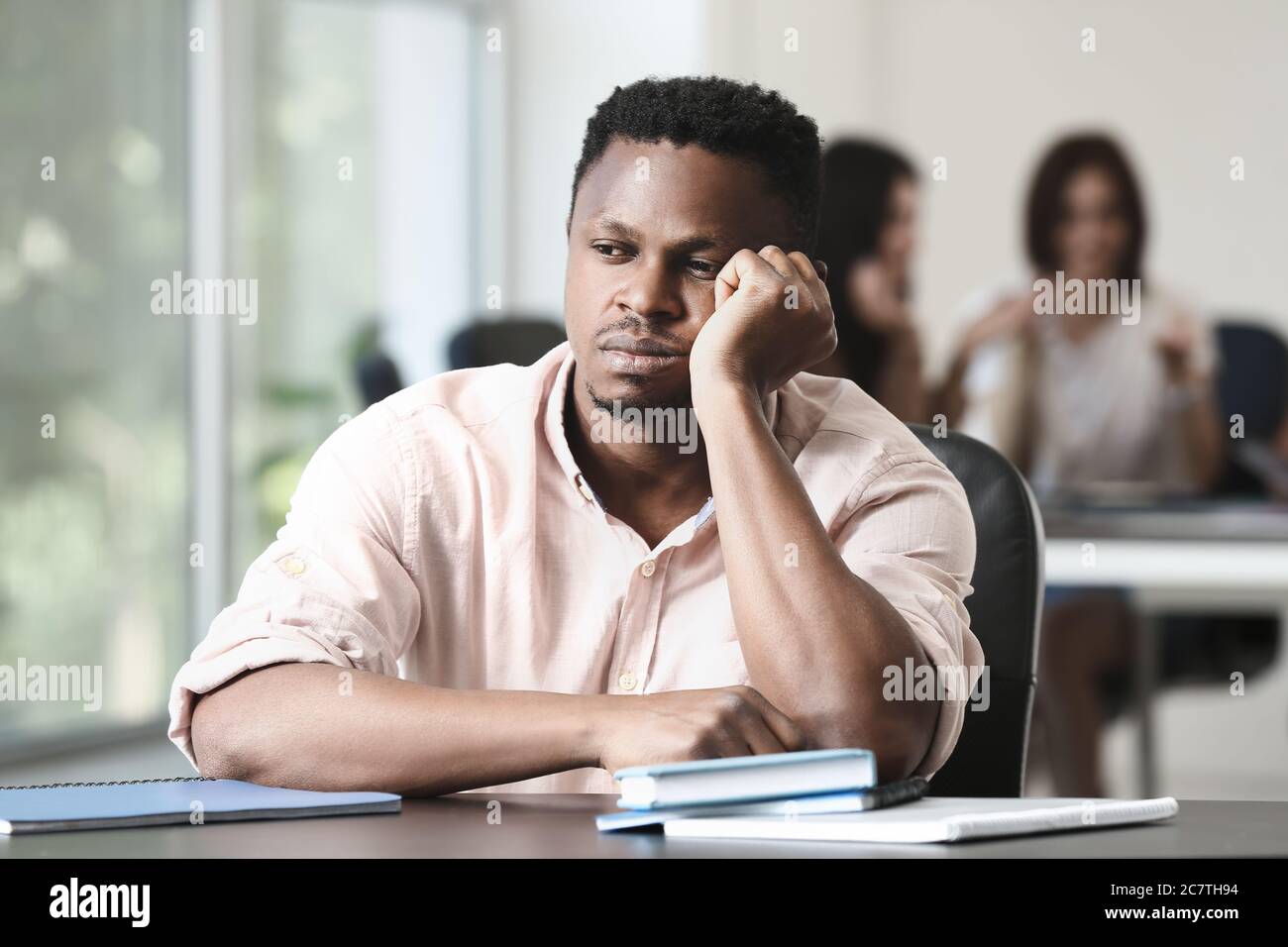 Lonely African-American man in office. Stop racism Stock Photo - Alamy