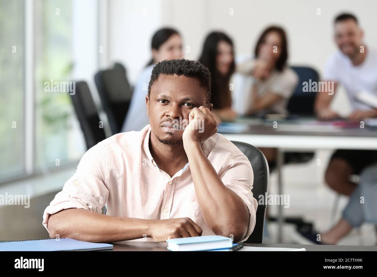 Lonely African-American man in office. Stop racism Stock Photo - Alamy