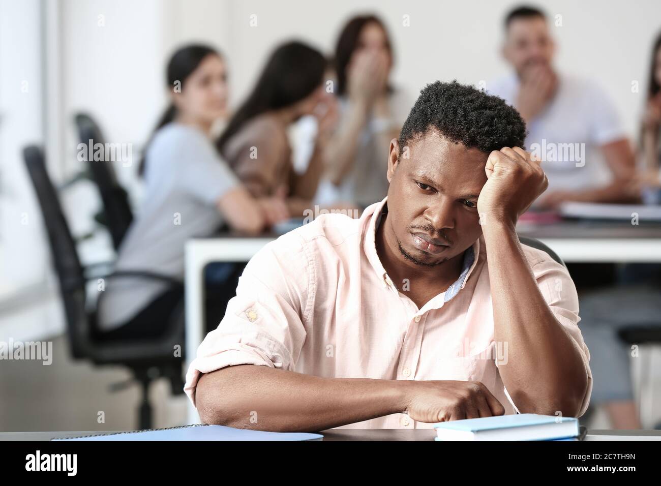 Lonely African-American man in office. Stop racism Stock Photo - Alamy