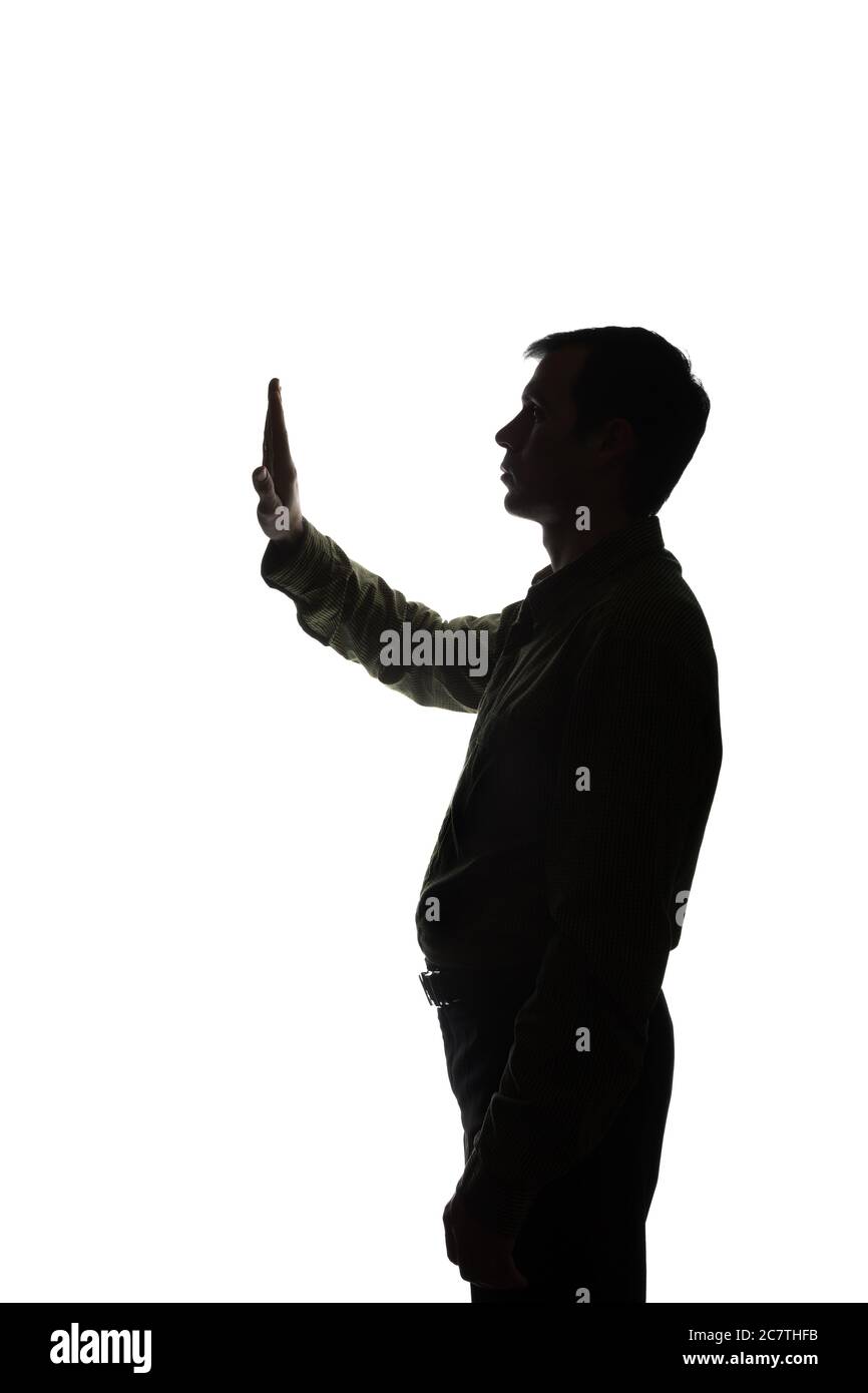 Portrait of a young man with his hands raised, side view - silhouette ...