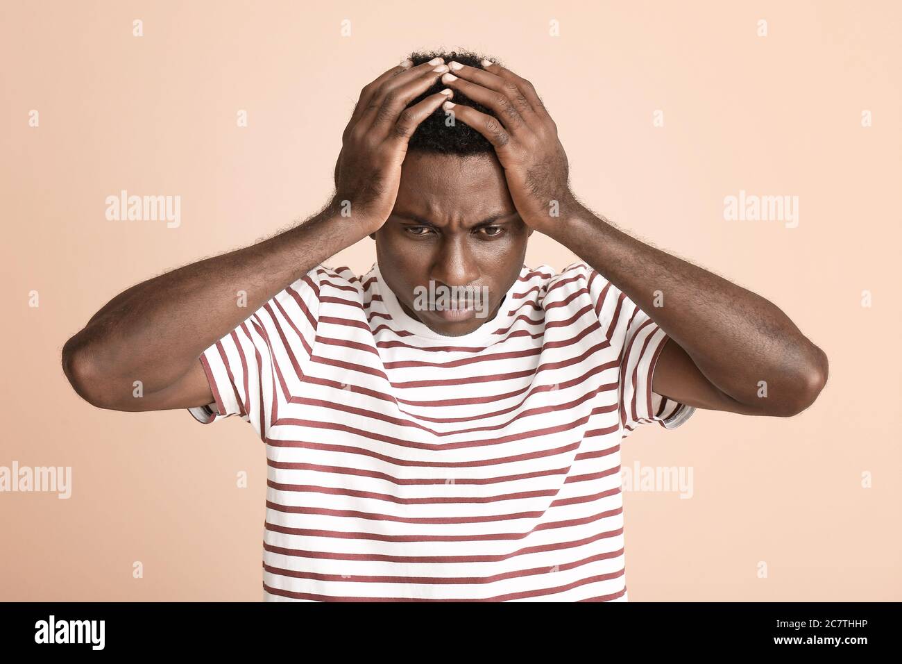 Stressed African-American man on color background. Stop racism Stock ...