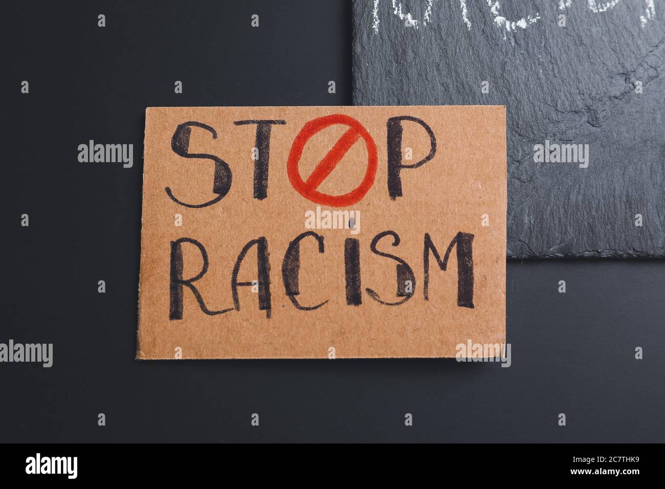 Placard with text STOP RACISM on dark background Stock Photo - Alamy