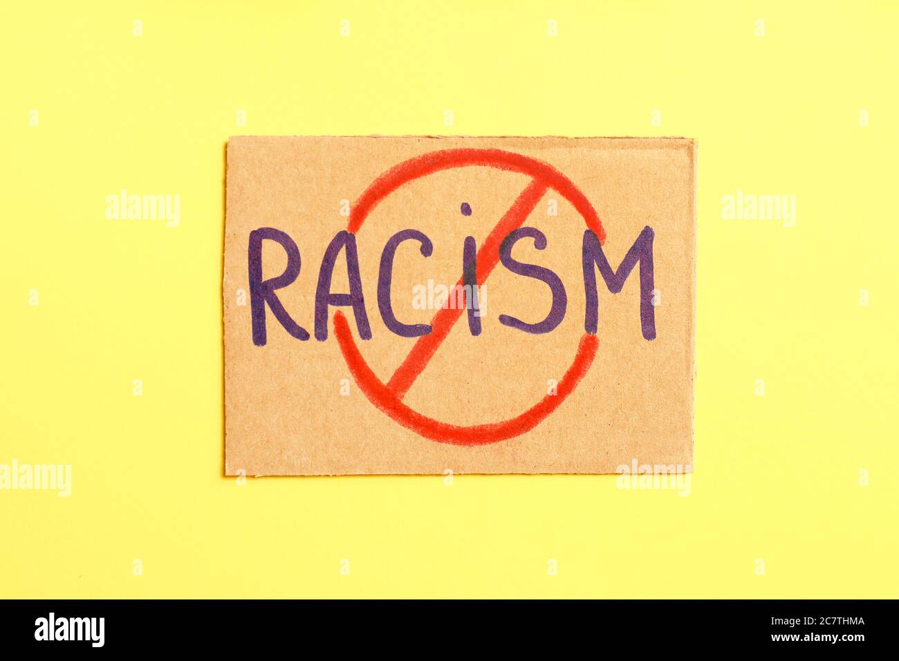 Placard with crossed out word RACISM on color background Stock Photo ...