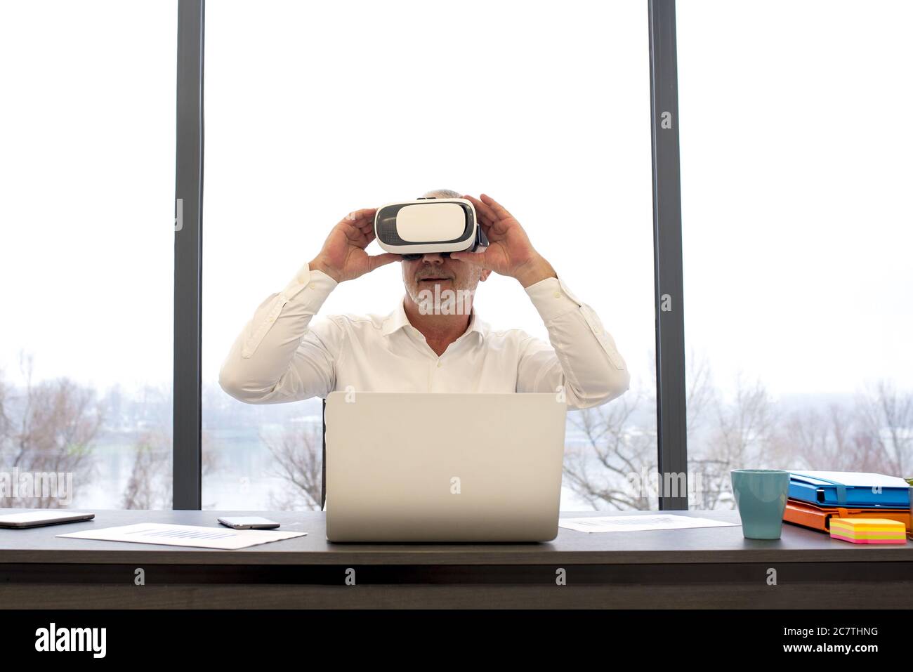 Male in a VR headset enjoying virtual project presentation at the ...