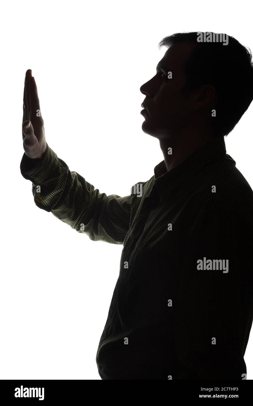 Portrait of a young man with his hands raised, side view - silhouette ...