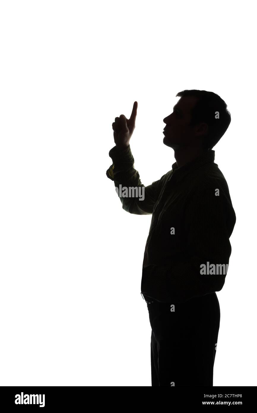 Portrait of a young man with his raised index finger, side view ...