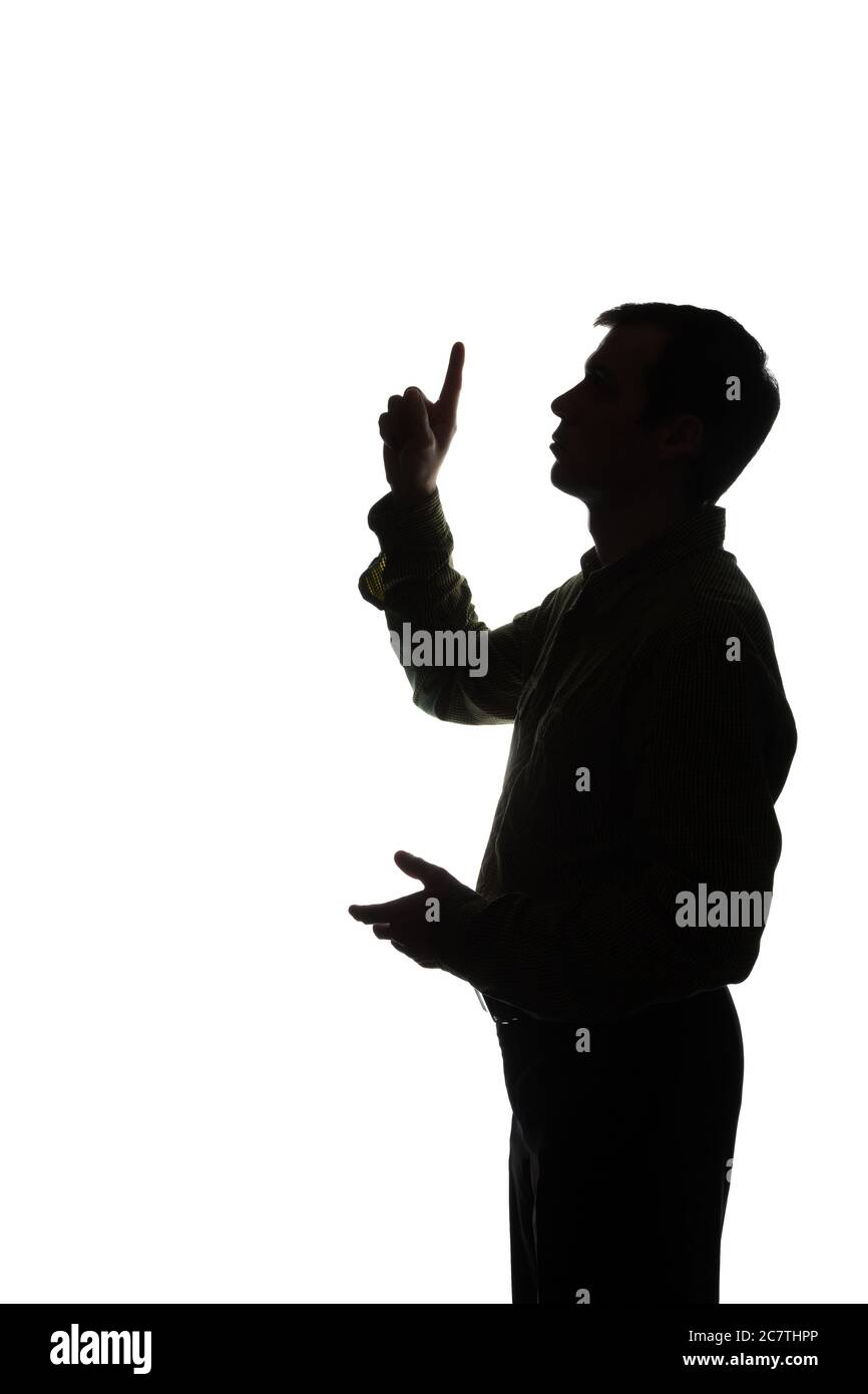 Portrait of a young man with his raised index finger, side view ...