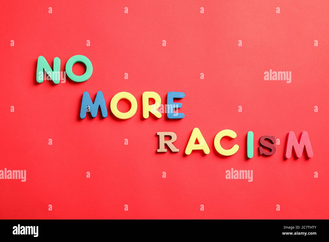 Text NO MORE RACISM on color background Stock Photo - Alamy