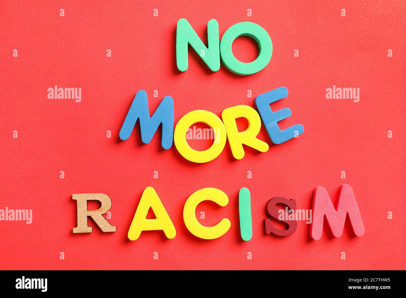 Text NO MORE RACISM on color background Stock Photo - Alamy