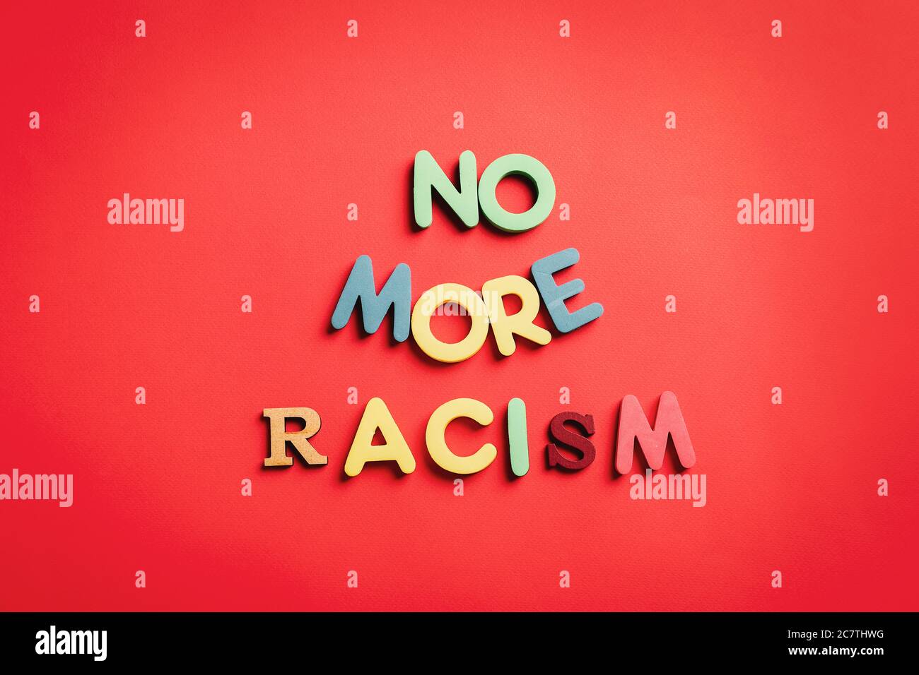 Text NO MORE RACISM on color background Stock Photo - Alamy