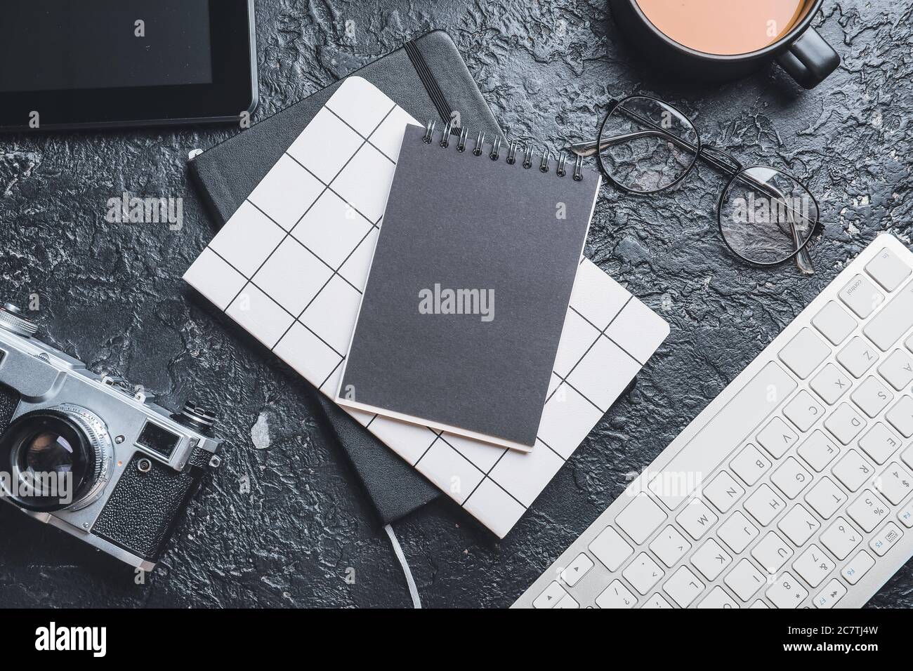 Composition with notebooks on dark background Stock Photo - Alamy