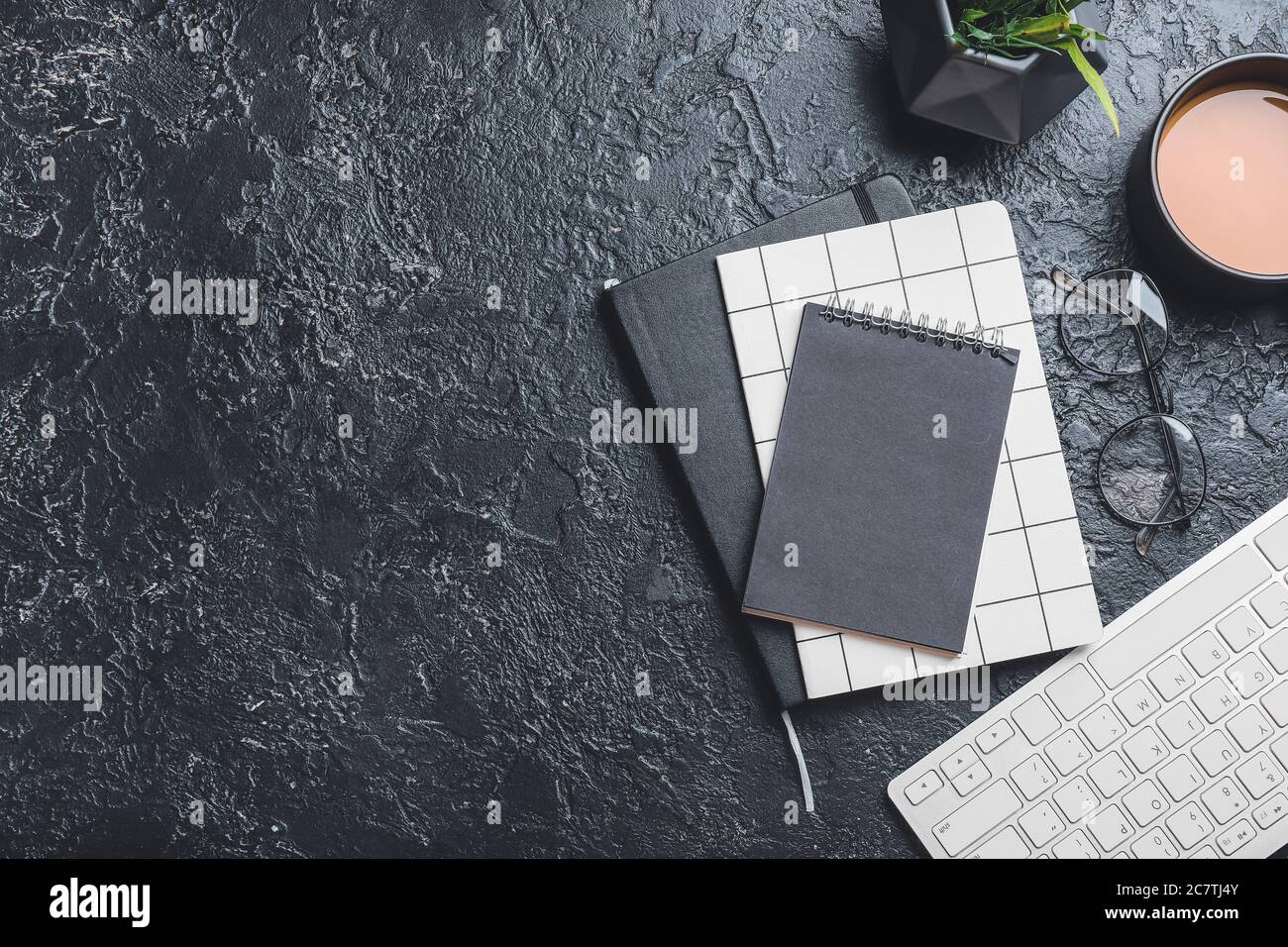 Composition with notebooks on dark background Stock Photo - Alamy