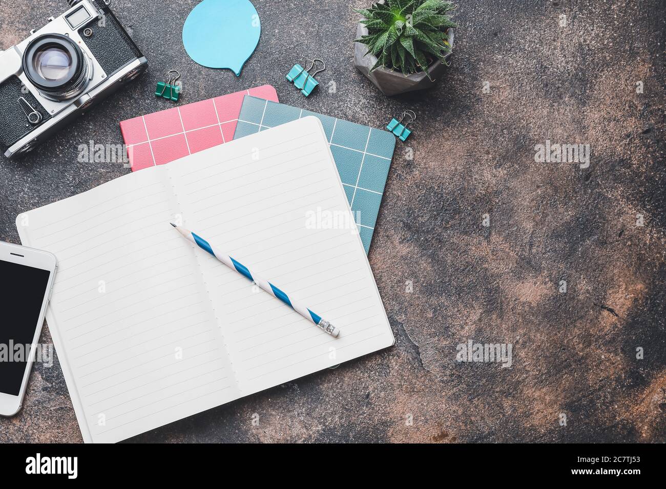 Composition with notebooks on dark background Stock Photo - Alamy