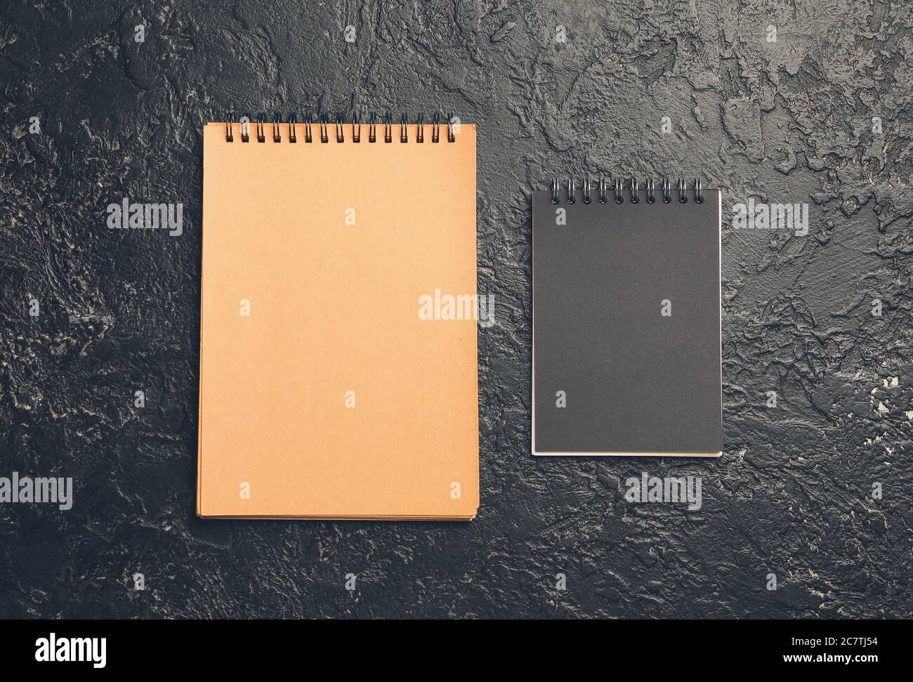Different notebooks on dark background Stock Photo - Alamy