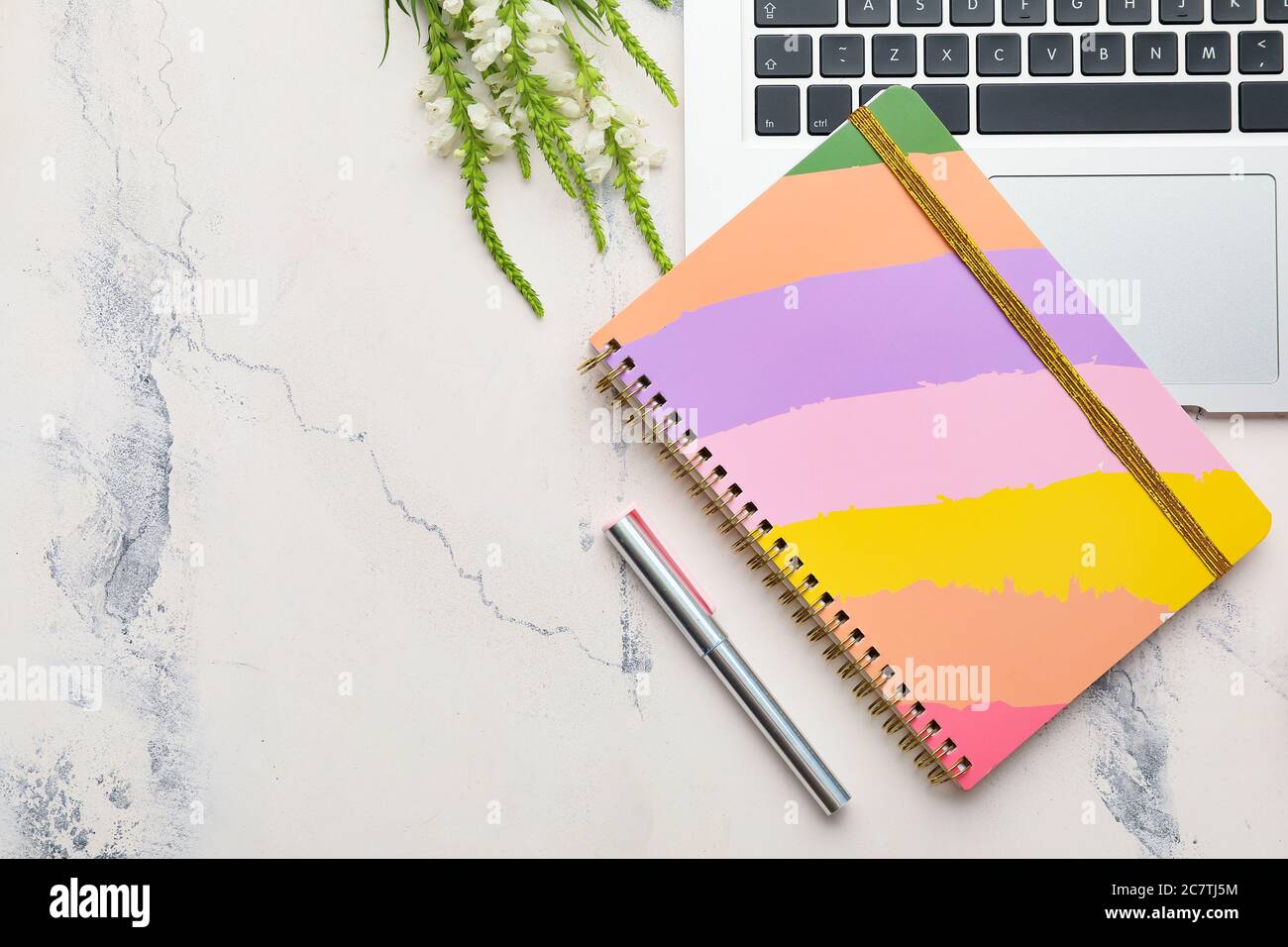 Notebook with laptop on white background Stock Photo - Alamy