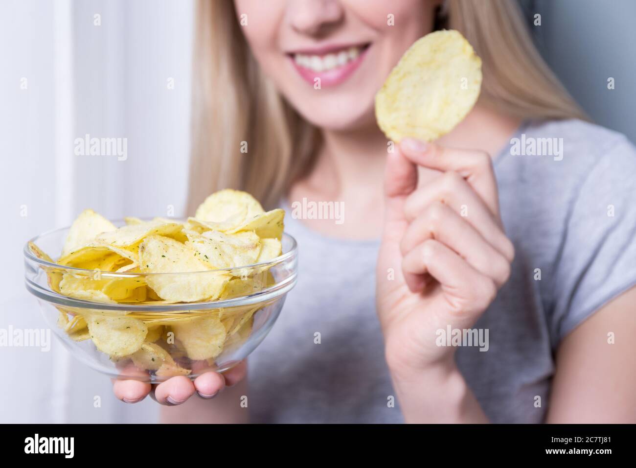 Girl holding potato chips in hi-res stock photography and images - Alamy