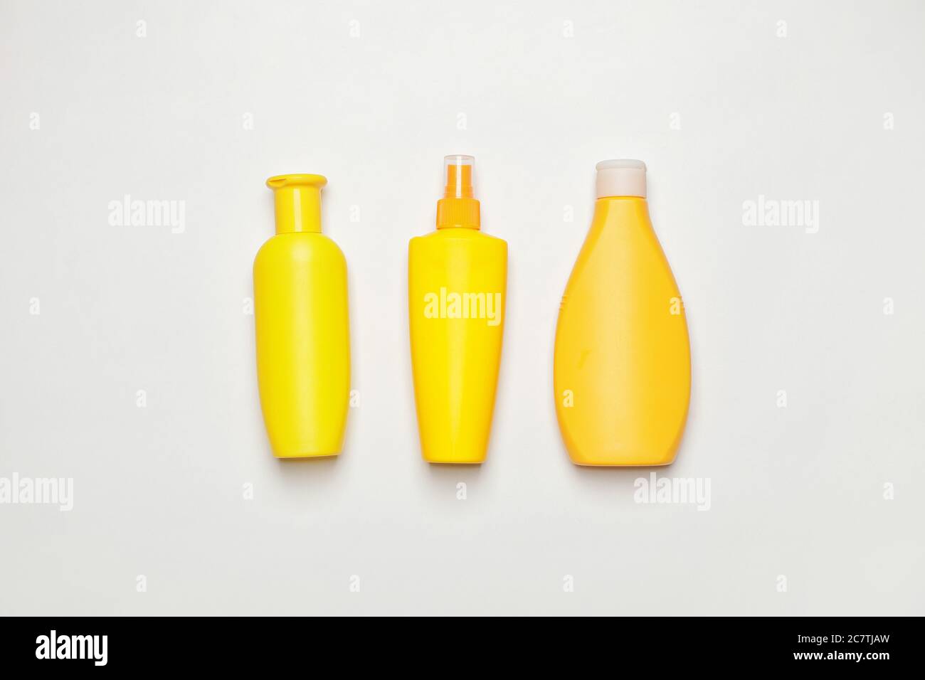 Bottles of sunscreen on white background Stock Photo - Alamy