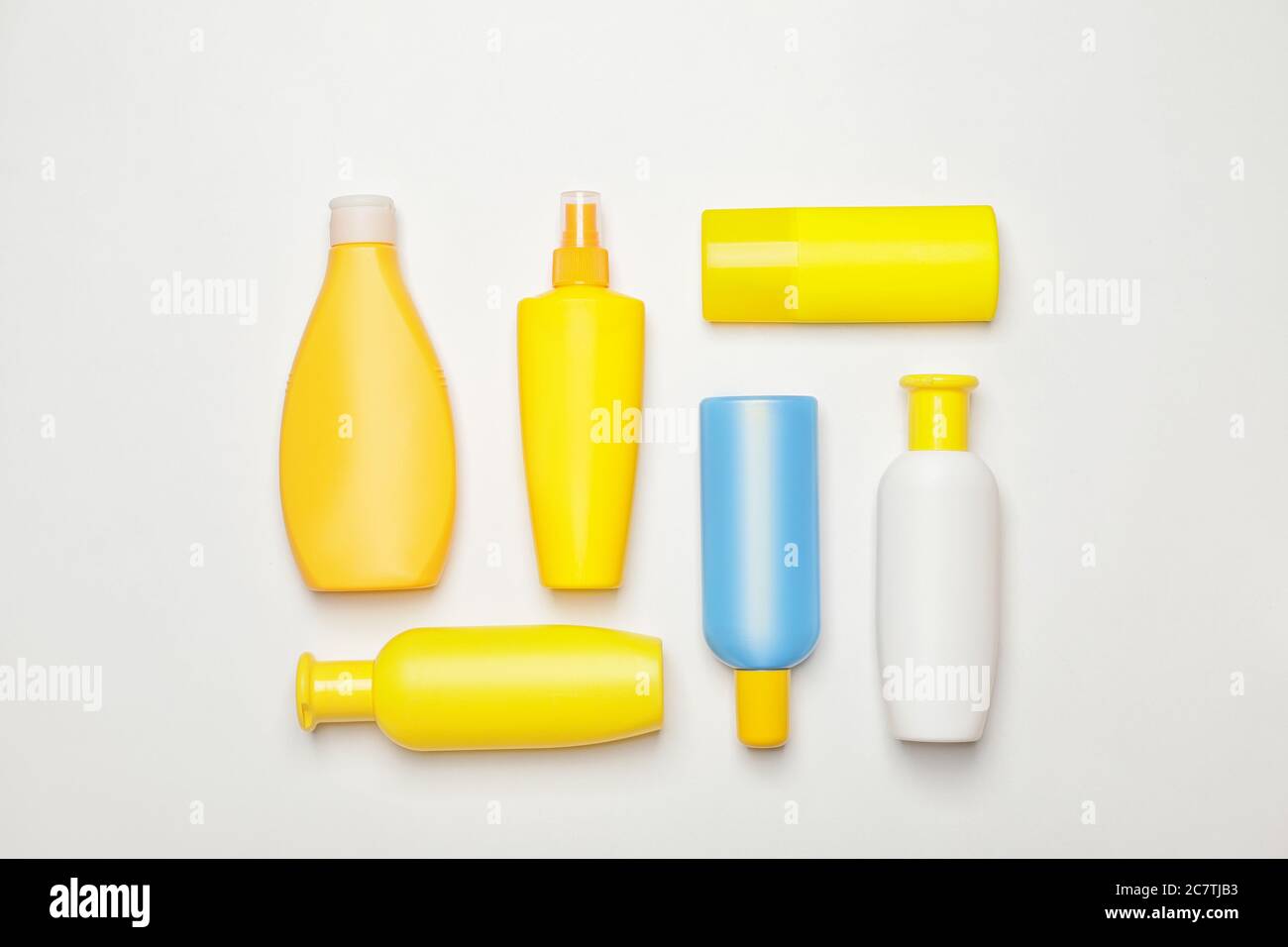 Bottles of sunscreen on white background Stock Photo - Alamy