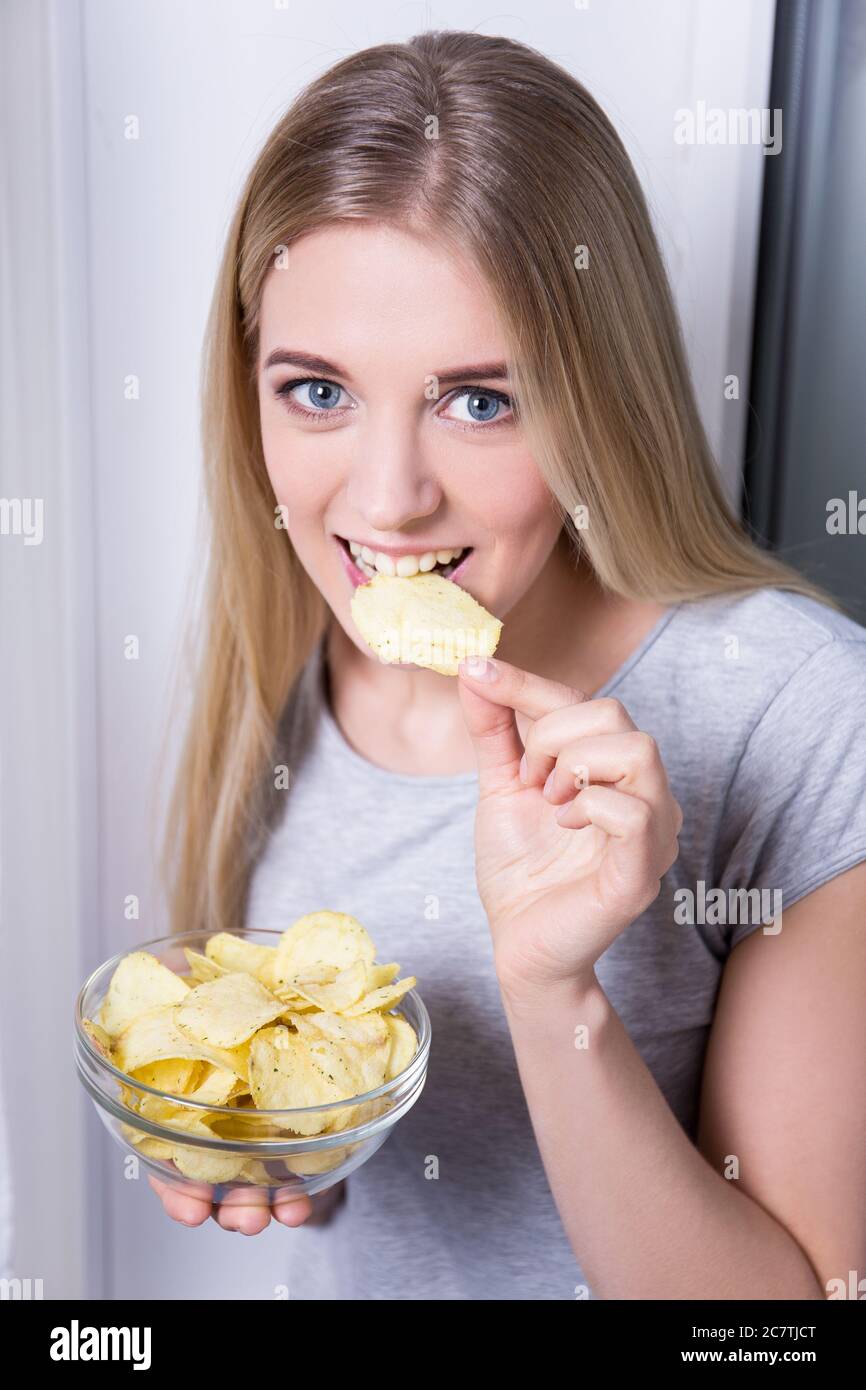 Teen girl eating chips hi-res stock photography and images - Alamy