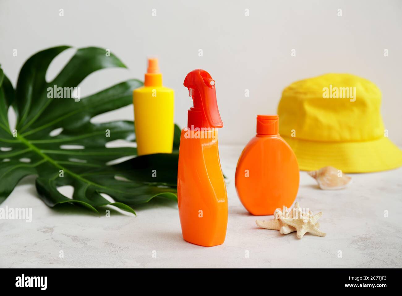 Bottles of sunscreen on light background Stock Photo - Alamy