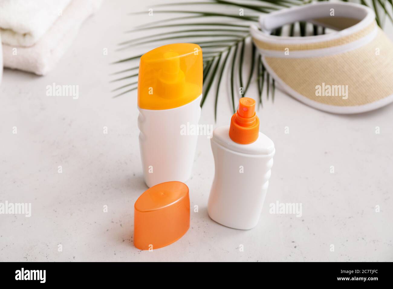 Bottles of sunscreen on light background Stock Photo - Alamy