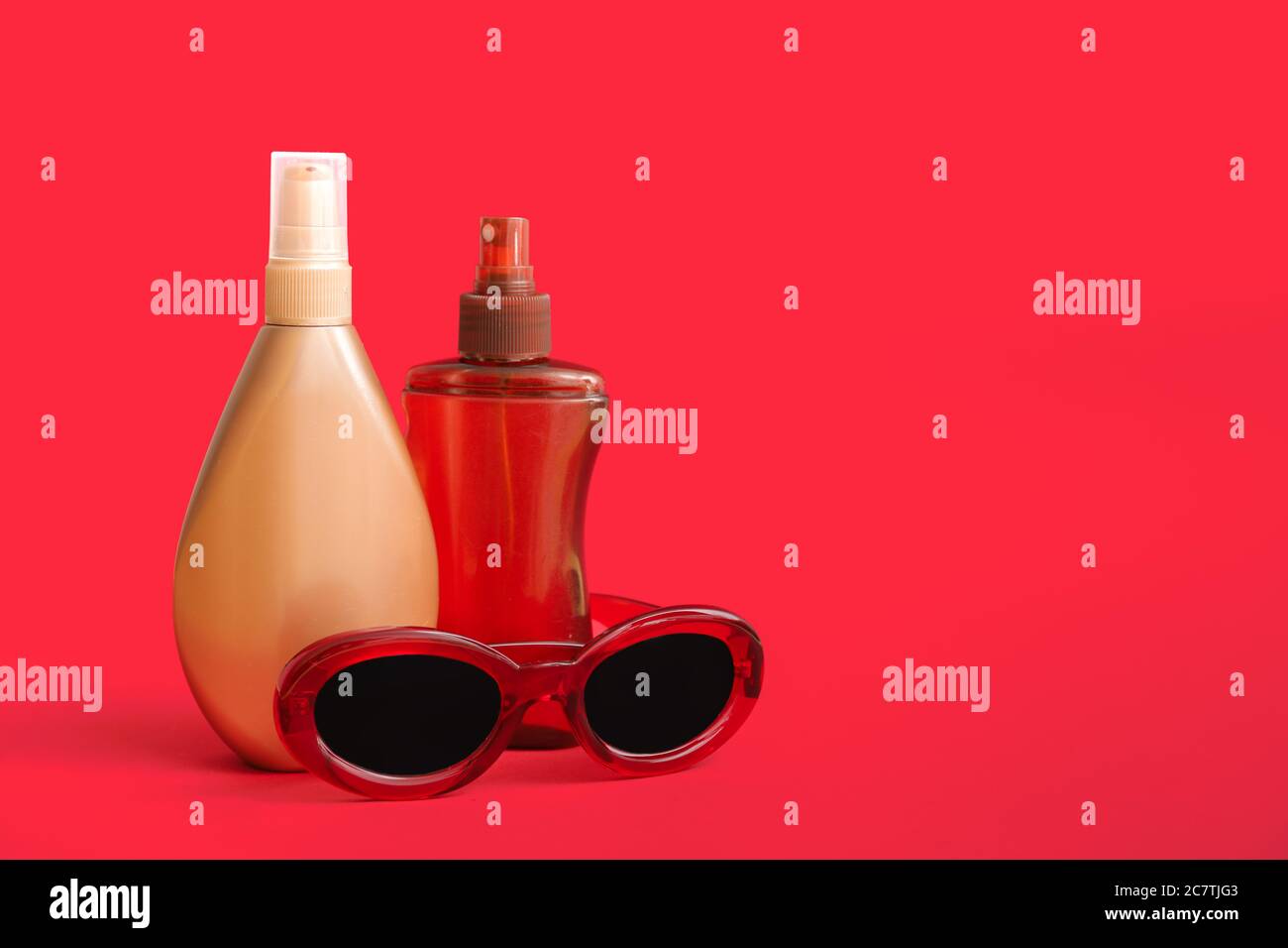 Bottles of sunscreen with sunglasses on color background Stock Photo ...