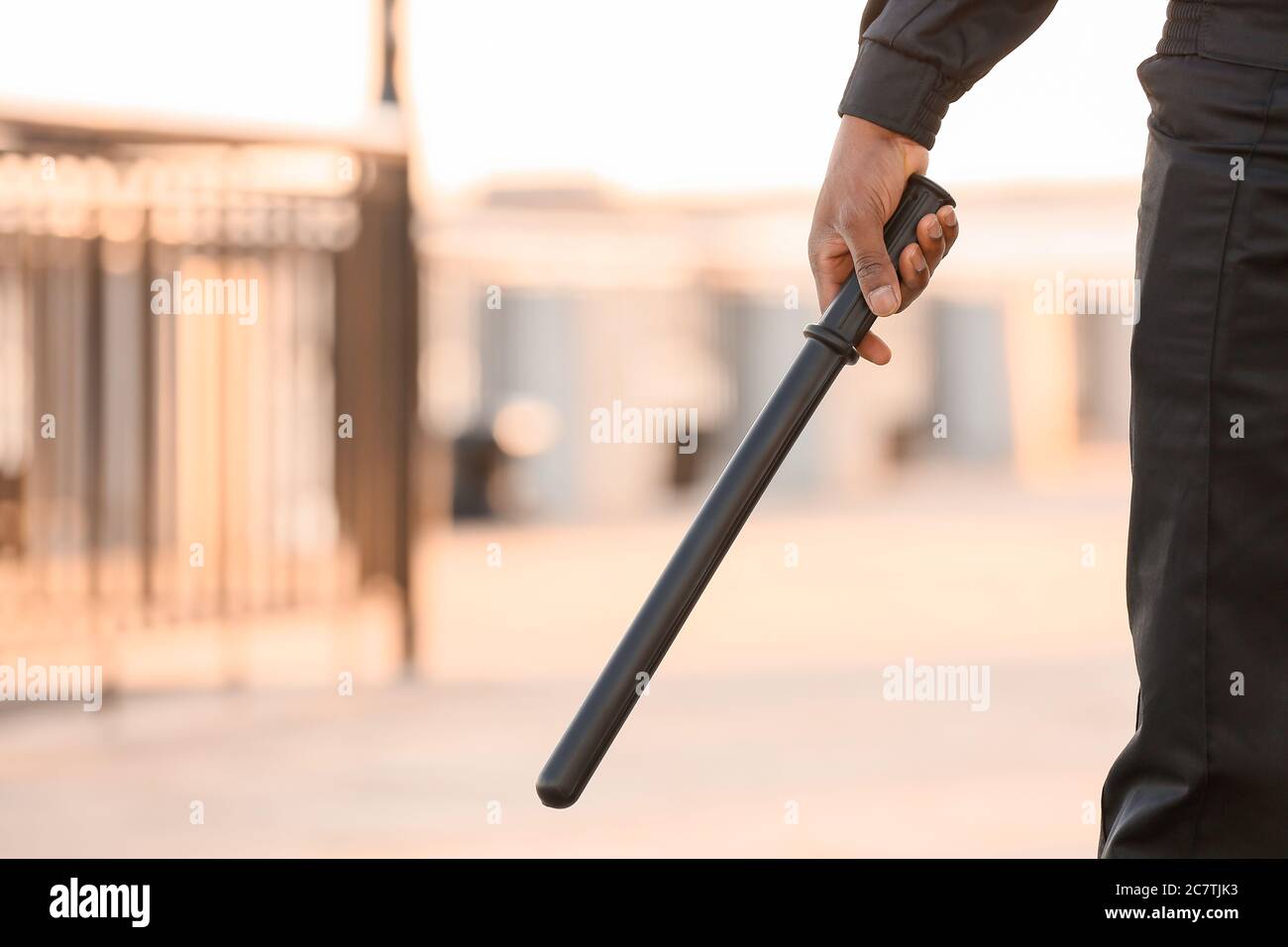 Aggressive African-American police officer with baton outdoors Stock ...
