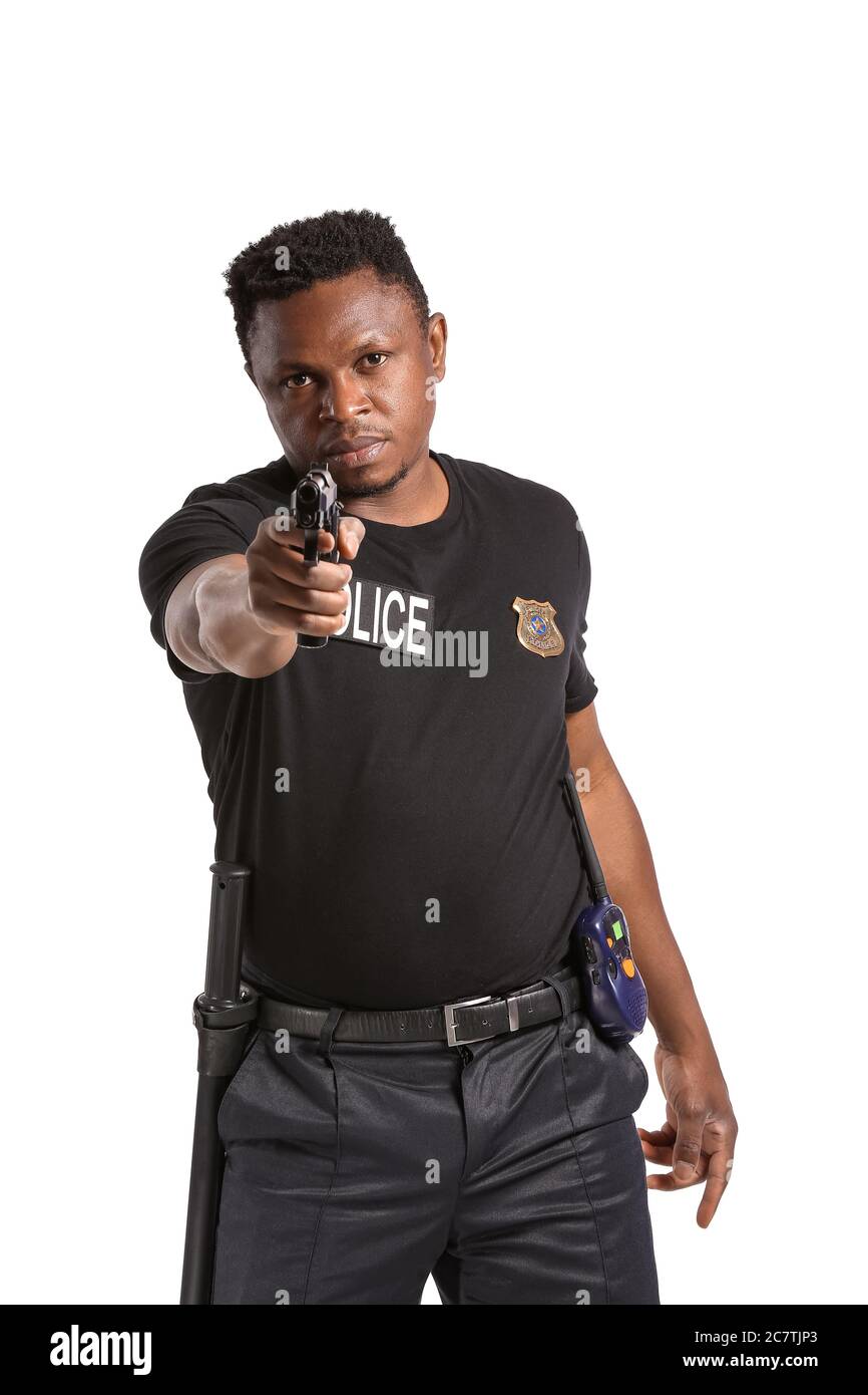 Aggressive African-American police officer with gun on white background ...