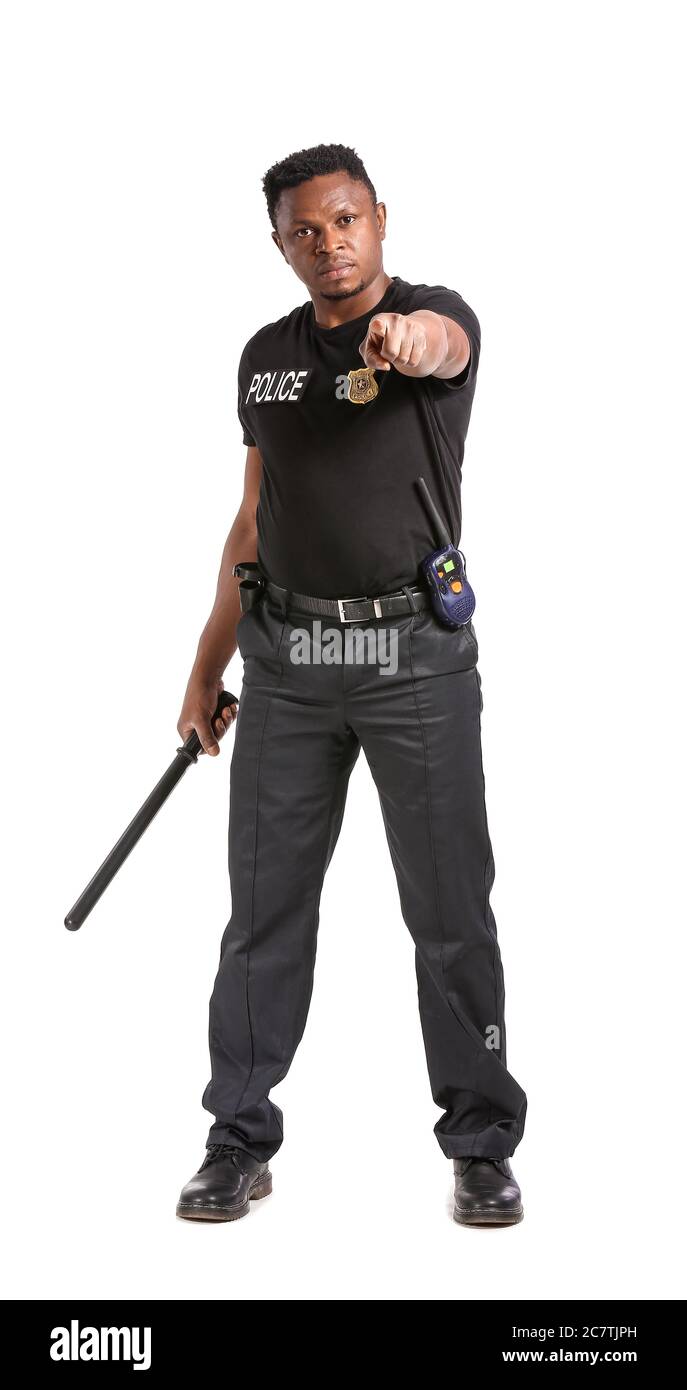 Aggressive African-American police officer with baton on white ...