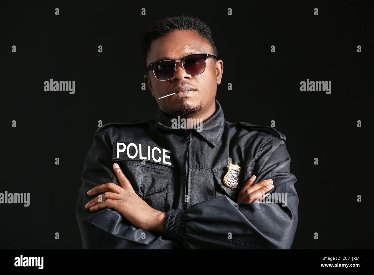 African-American police officer on dark background Stock Photo - Alamy