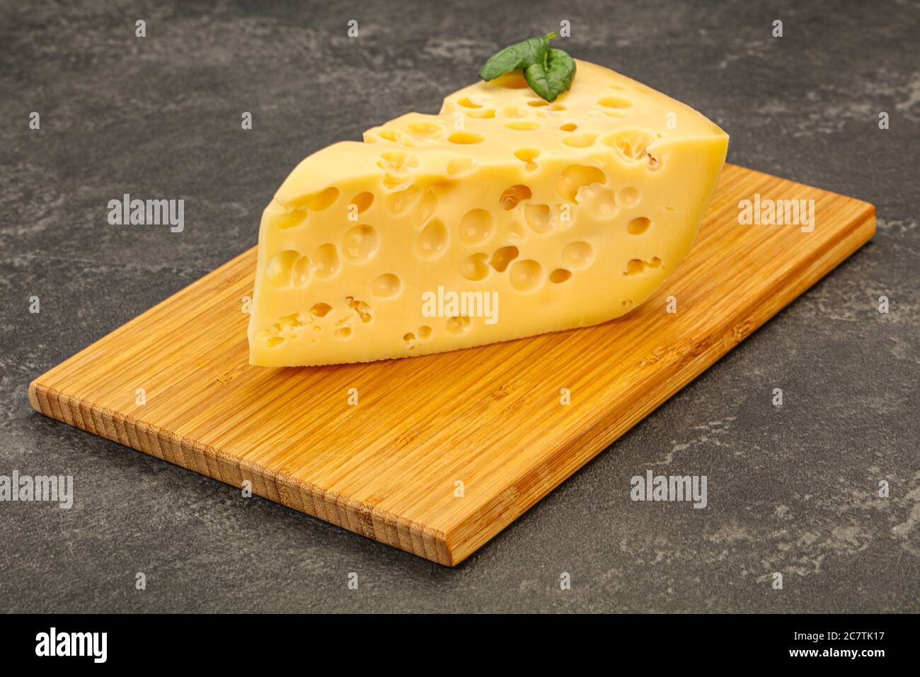Maasdam cheese - dairy yellow triangle with holes Stock Photo - Alamy