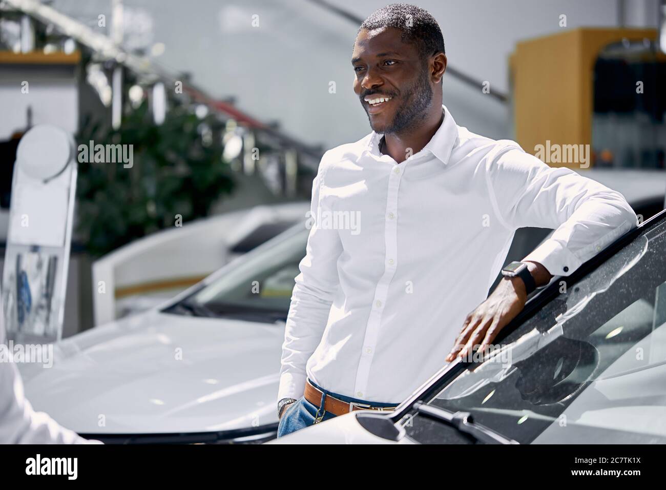 young africanamerican man came to see automobiles in dealership or cars ...
