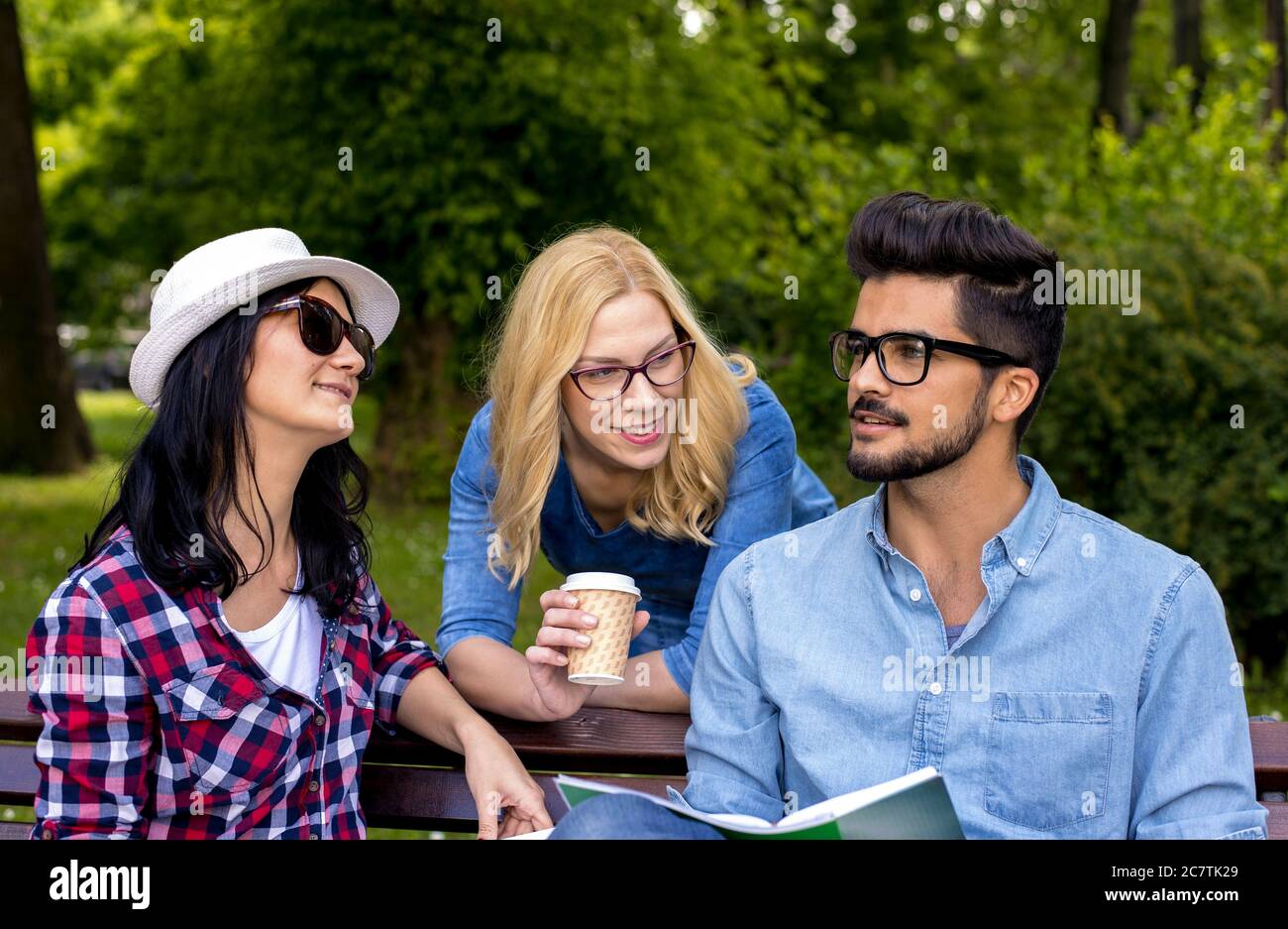 Students having fun while doing homework together in campus park Stock ...