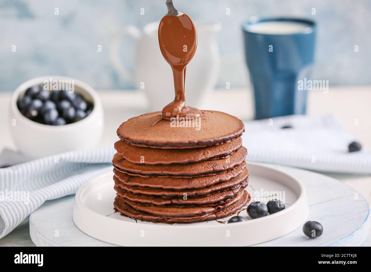 Decorating of delicious chocolate pancakes Stock Photo - Alamy