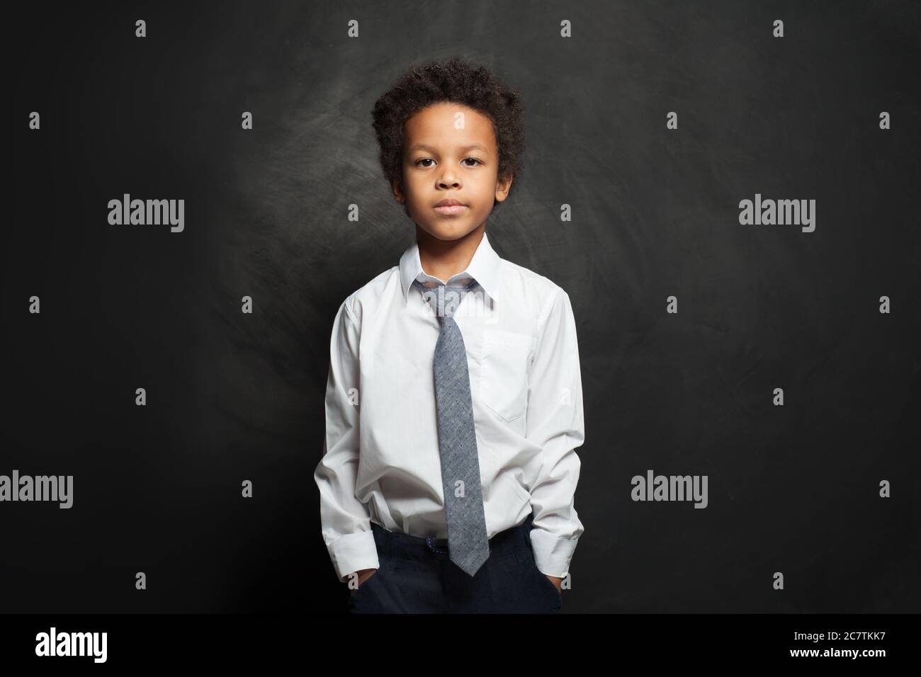 Smart successful serious black child boy student on black background ...
