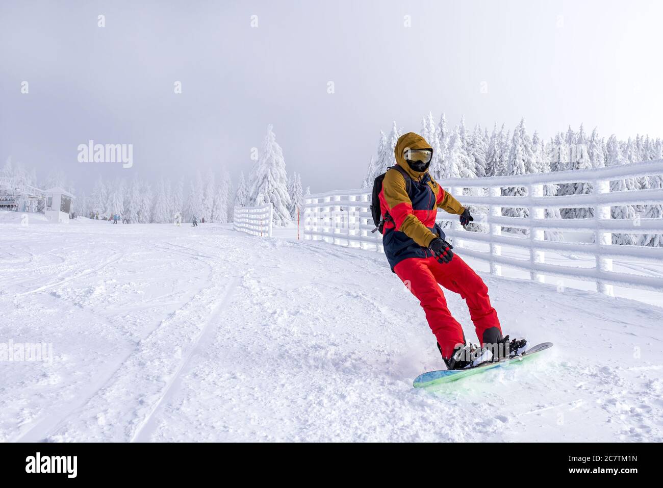 Snowboarder sliding through the slope at a mountain resort Stock Photo ...
