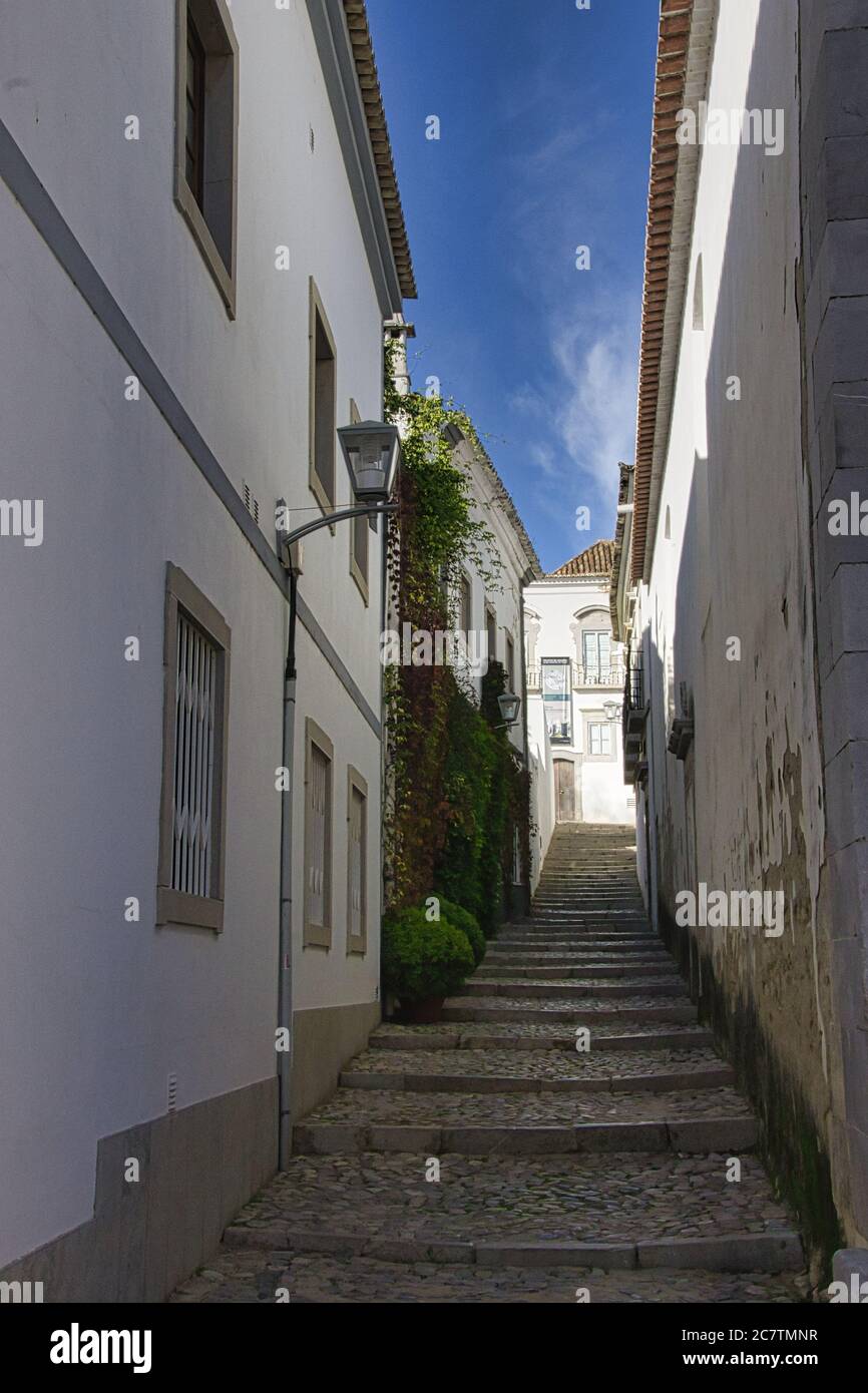 Narrow uphill alley with small steps between apartment buildings Stock ...