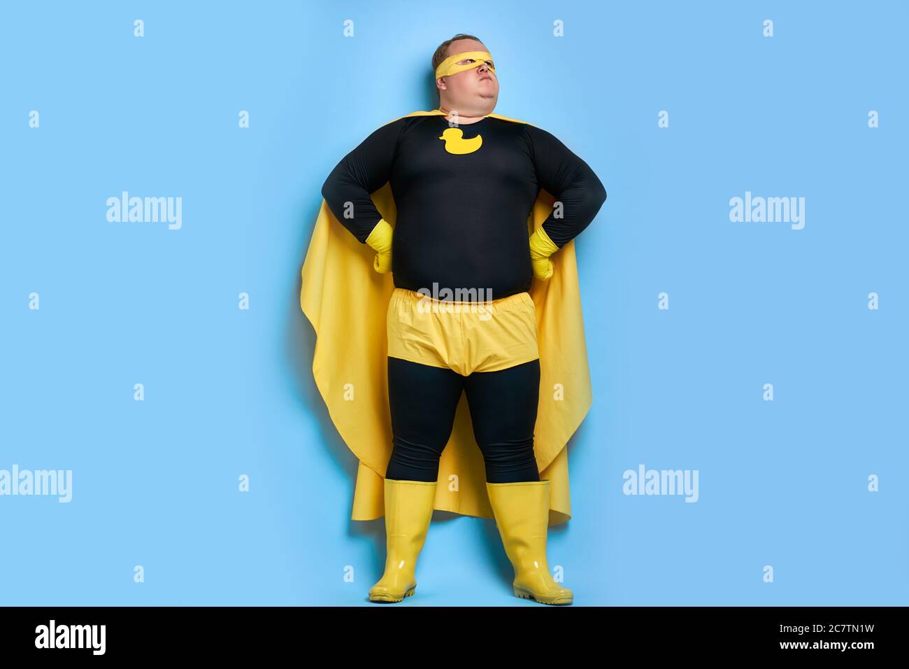 serious overweight super hero man is defender of the universe, strong ...