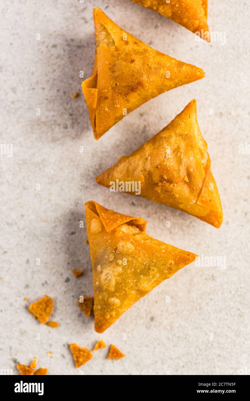 Vertical shot of aligned samosa with a white background Stock Photo - Alamy