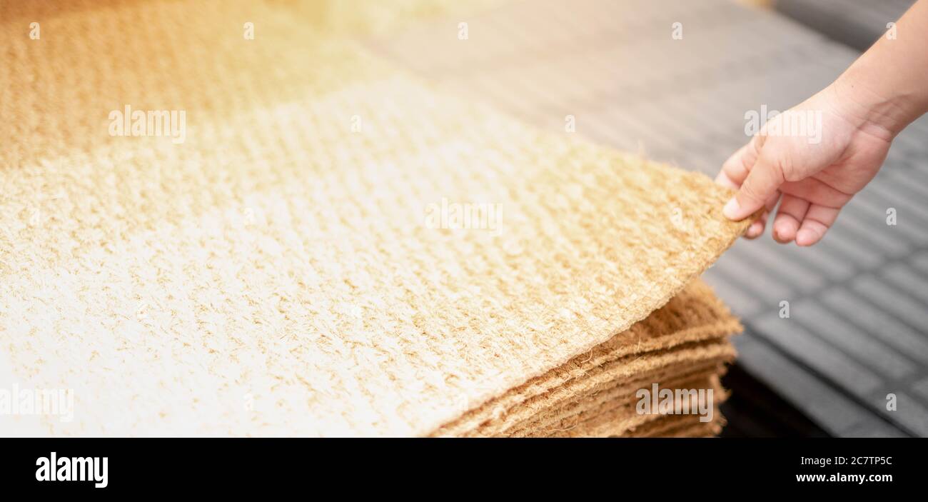 The female hand choosing the rug for use inside the house, The rug in ...