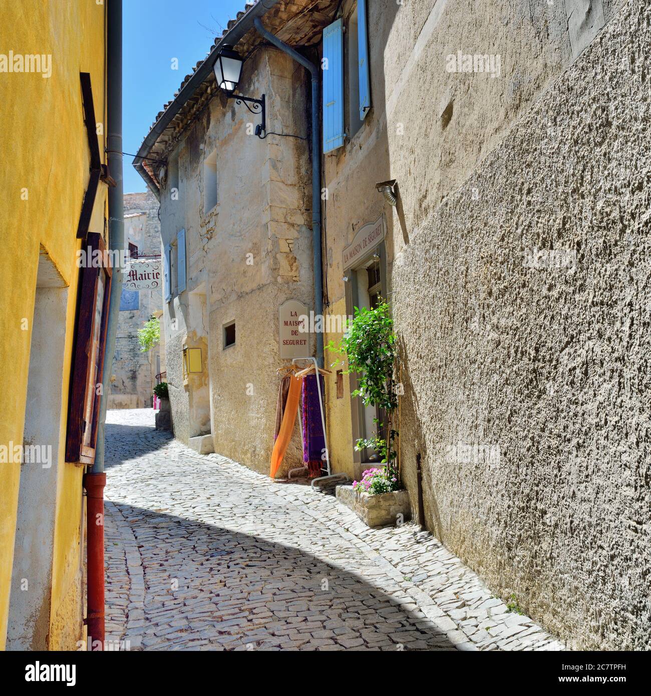 SEGURET, FRANCE - JUL 11, 2014: Narrow medieval street in small village ...