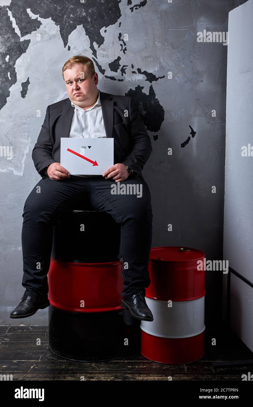 dolorous caucasian fat oilman is disappointed with price drop, he sits ...