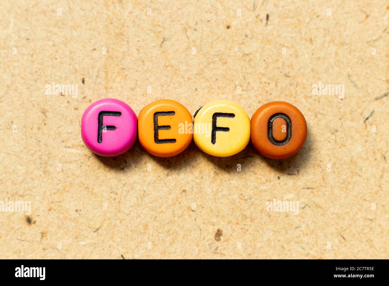 Round color bead with black letter in word FEFO (first expired first ...