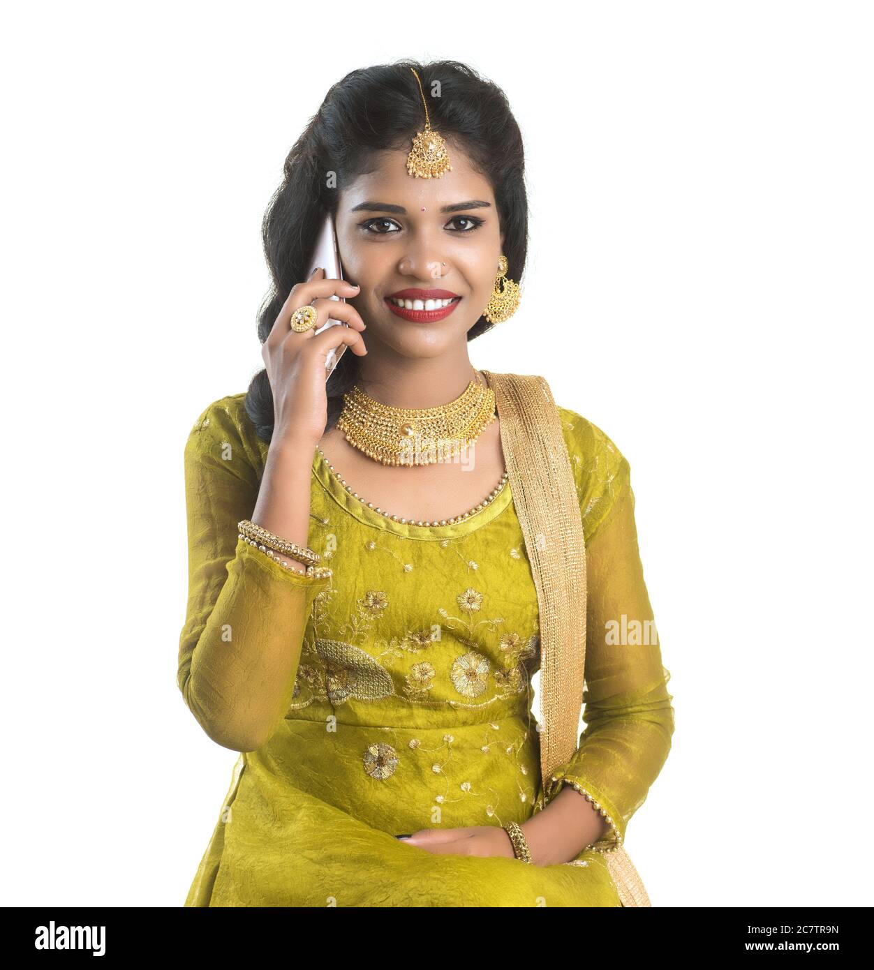 Young Indian traditional girl using a mobile phone or smartphone ...