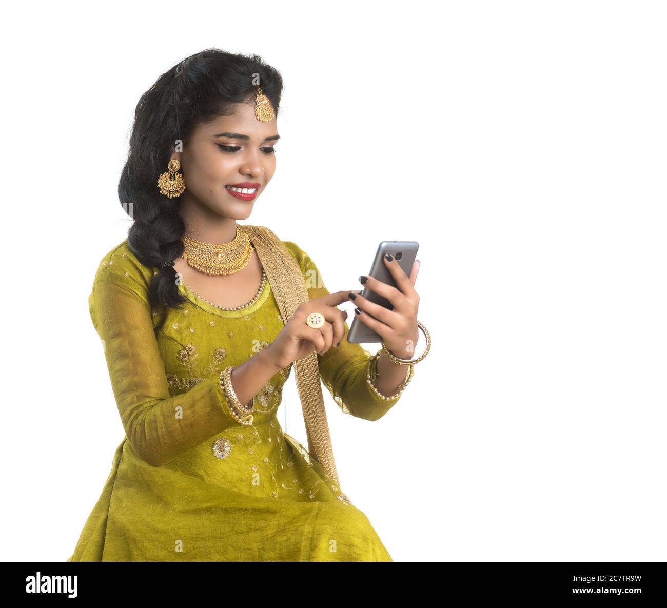 Young Indian traditional girl using a mobile phone or smartphone ...