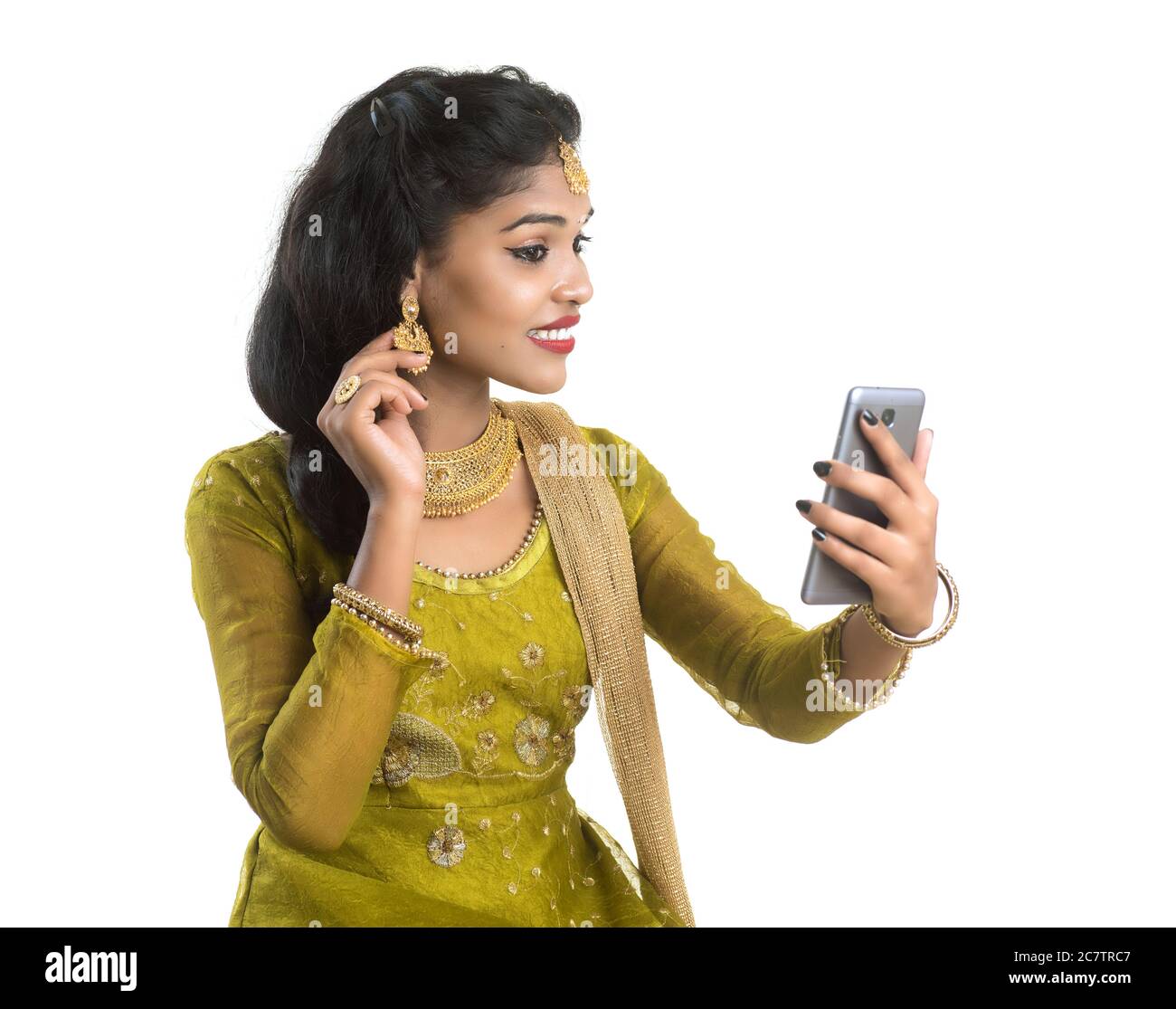 Young Indian traditional girl using a mobile phone or smartphone ...