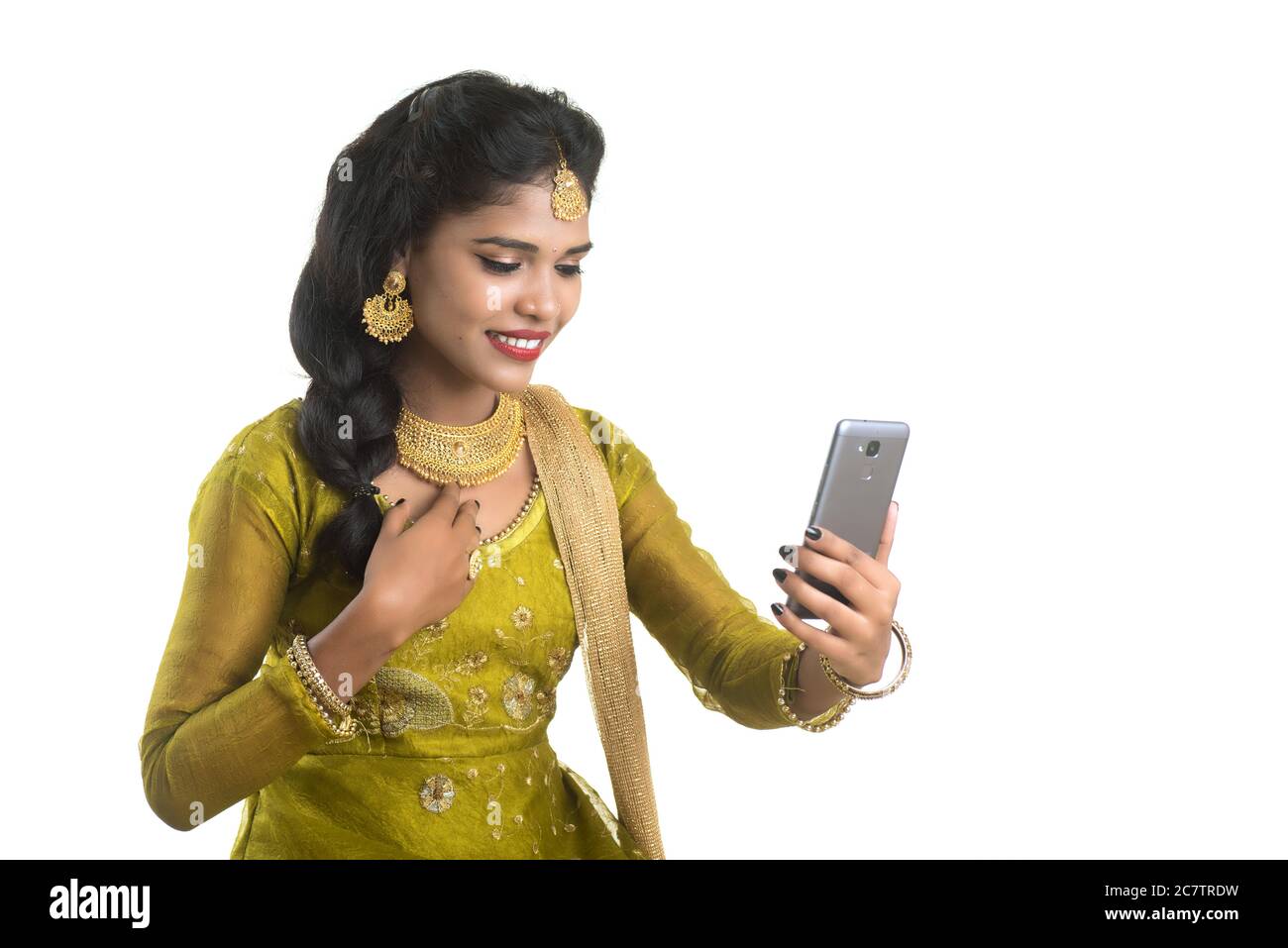 Young Indian traditional girl using a mobile phone or smartphone ...