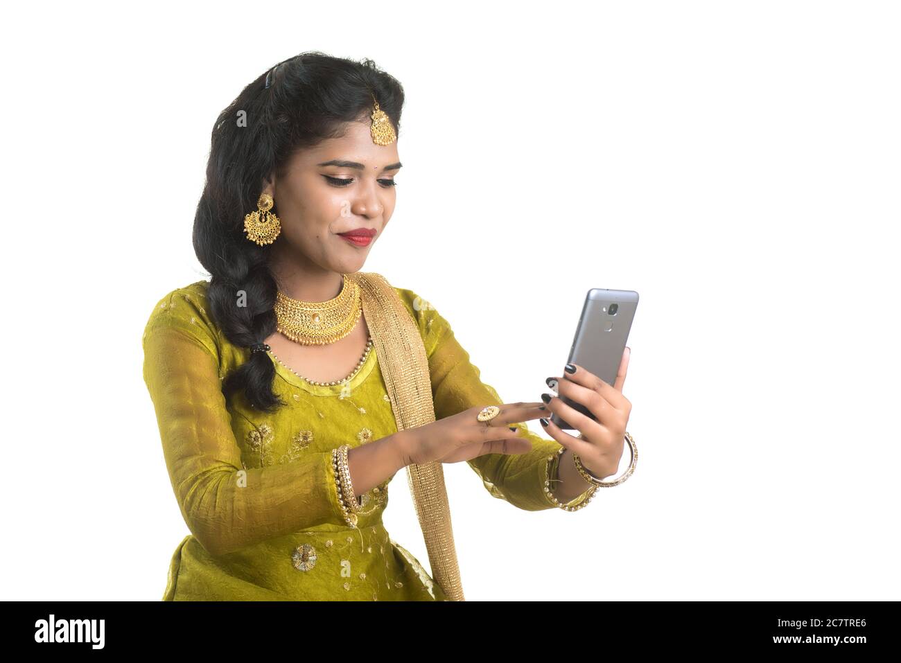 Young Indian traditional girl using a mobile phone or smartphone ...